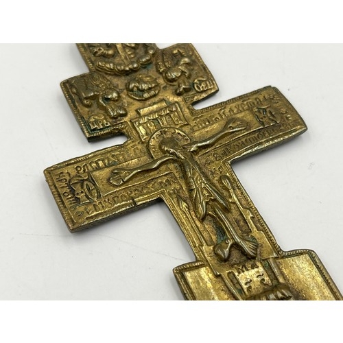An antique Russian Orthodox brass wall cross - approx. 11cm high x 6cm wide
