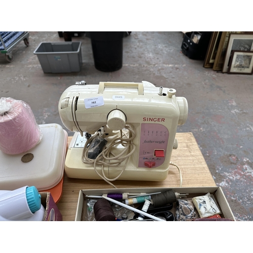 A collection of sewing items to include Singer Featherweight 100 ...