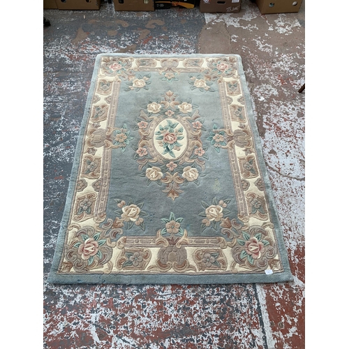 A Chinese floral pattern rug - approx. 6ft x 4ft