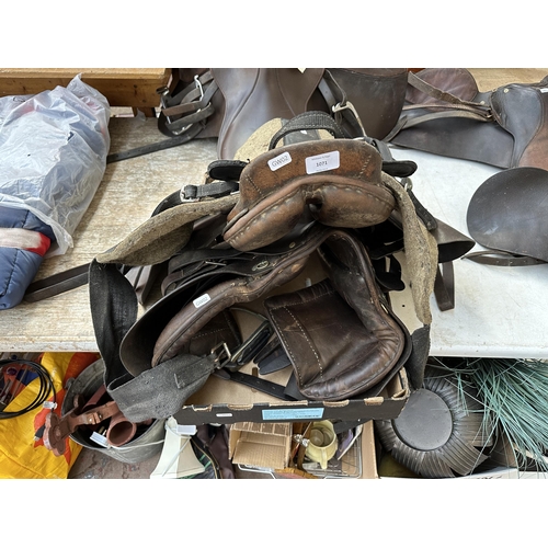 A box containing three saddles, one 15" donkey saddle with stirrups ...