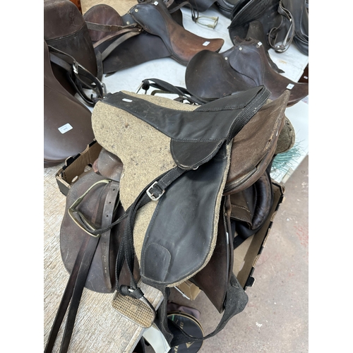 A box containing three saddles, one 15" donkey saddle with stirrups ...