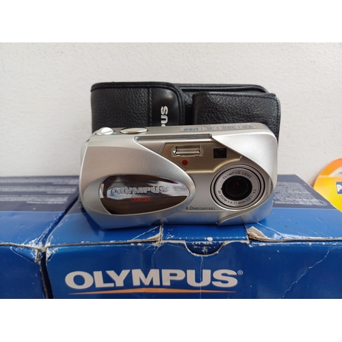 Two boxed Olympus compact digital cameras with software discs, xD ...