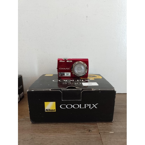 Four boxed Nikon CoolPix compact digital cameras, one S225 10mp, one ...