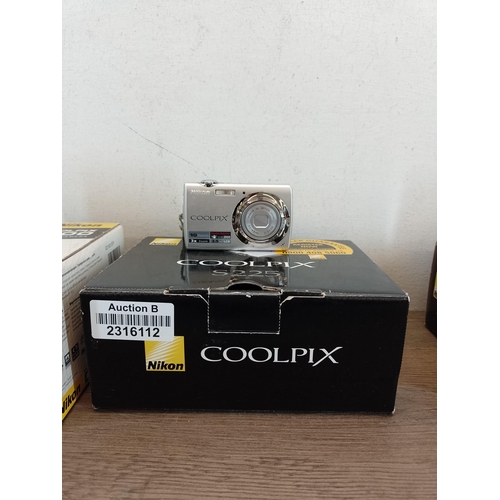 Four boxed Nikon CoolPix compact digital cameras, one S225 10mp, one ...