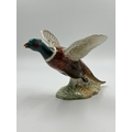 A Beswick Pheasant figurine, model no. 849 - approx. 15cm high x 27cm long
