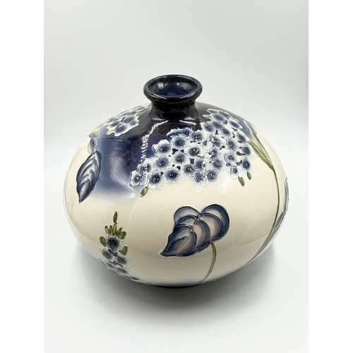 A Moorcroft style tubelined ceramic vase - approx. 29cm high