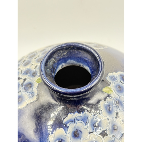 A Moorcroft style tubelined ceramic vase - approx. 29cm high