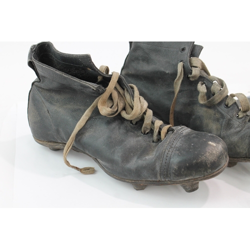 A pair of early-mid 20th century leather football boots together with ...
