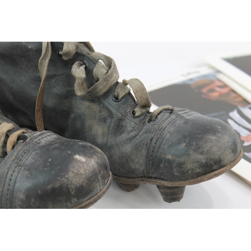 A pair of early-mid 20th century leather football boots together with ...