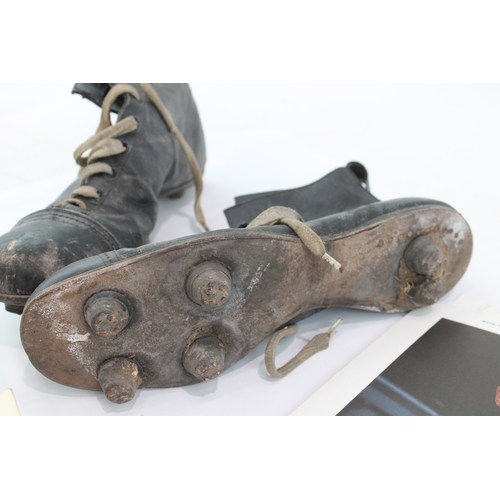 A pair of early-mid 20th century leather football boots together with ...