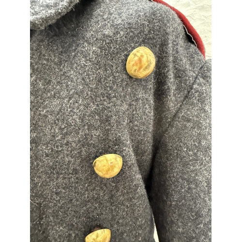 A post WWII Bulgarian wool three quarter length overcoat with red piping