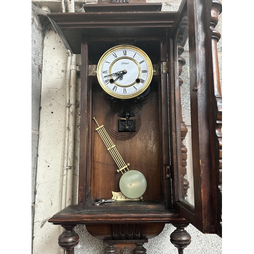 A Highlands mahogany cased chiming wall clock with pendulum and key ...