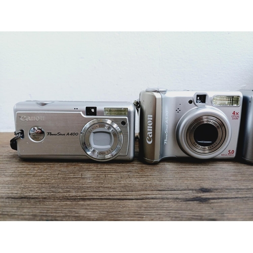 Four Canon PowerShot CCD sensor compact digital cameras, one cased A710 ...
