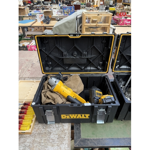 A DeWalt T Stack toolbox containing cordless DCG412 angle grinder with ...