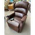 A HSL brown leather electric reclining armchair with power supply and ...