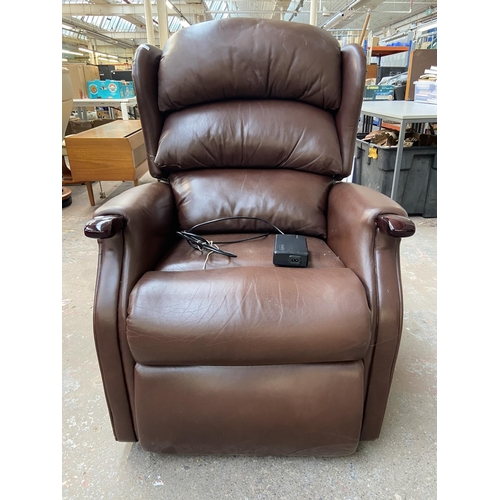 A HSL brown leather electric reclining armchair with power supply and ...