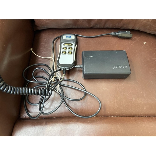 A HSL brown leather electric reclining armchair with power supply and ...