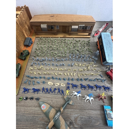 A collection of diecast model vehicles together with toy soldiers and a ...