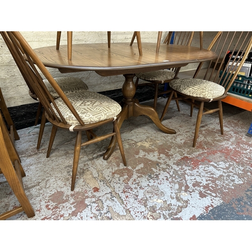 An Ercol Golden Dawn elm and beech extending dining table and six ...