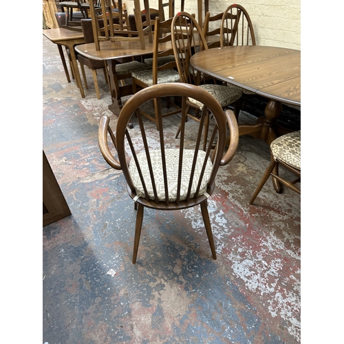 An Ercol Golden Dawn elm and beech extending dining table and six ...