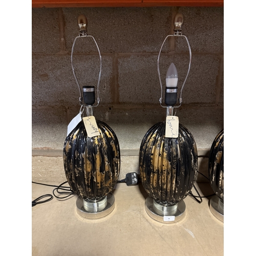 A set of four CIMC Home black and gold ceramic table lamps on chrome ...