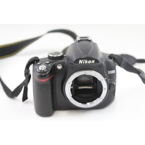 A Nikon D5000 12mp APS-C CMOS sensor DSLR camera body with Nikon strap