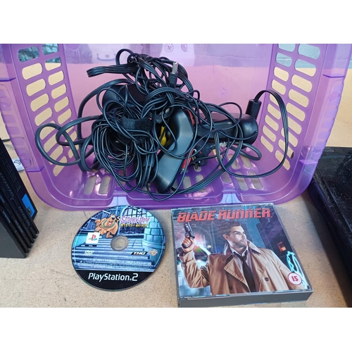 Two games consoles, one Sony PlayStation 2 and one Nintendo Wii U with ...