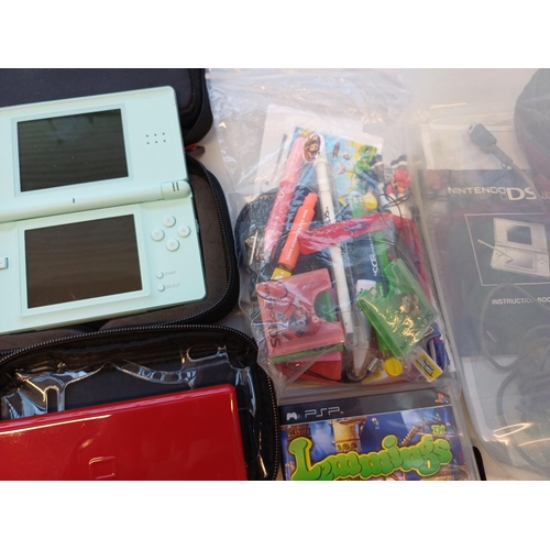 A collection of handheld gaming items to include two cased Nintendo DS ...