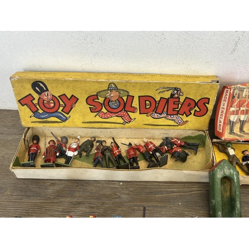 A collection of vintage metal toy soldiers, two boxed, two bags
