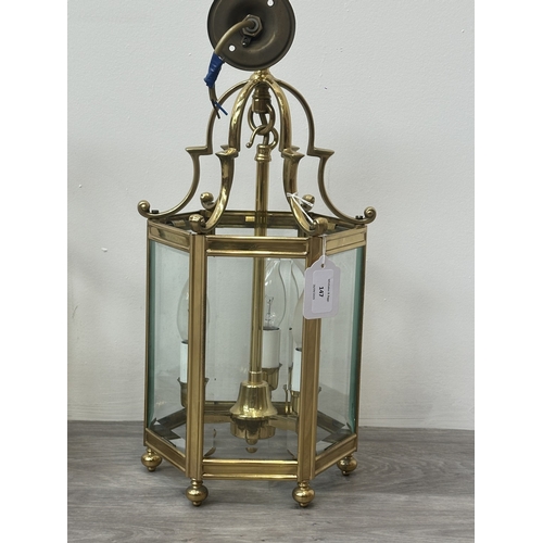 A pair of Christopher Wray style brass and bevelled glass hexagonal ...