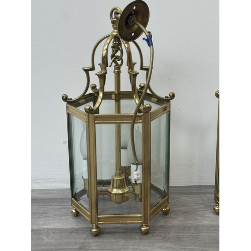 A pair of Christopher Wray style brass and bevelled glass hexagonal ...