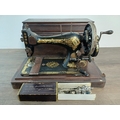 A cased 1895 Singer 28K hand-crank sewing machine with boxed accessories