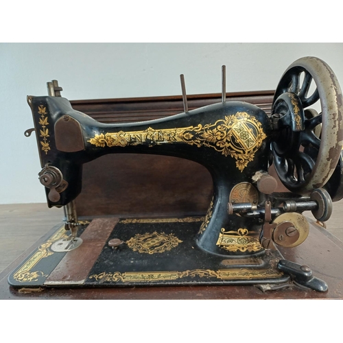 A cased 1895 Singer 28K hand-crank sewing machine with boxed accessories