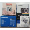 Four boxed digital cameras, one Panasonic SDR-S7 SD camcorder with ...