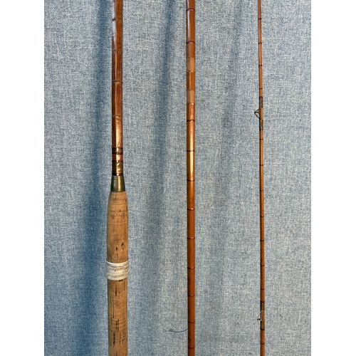 A cased three piece split cane fishing rod
