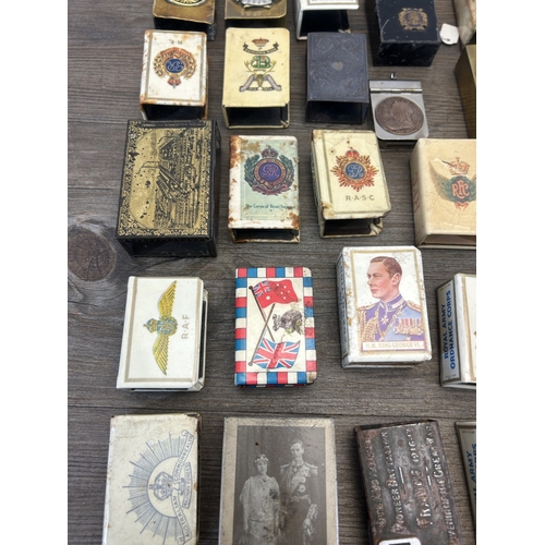 Seventy six Victorian and later mostly military themed matchbox holders ...