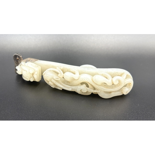A Chinese carved jade and white metal belt hook with dragon design ...