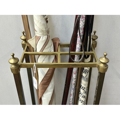A brass and cast iron four section stick stand containing six various ...