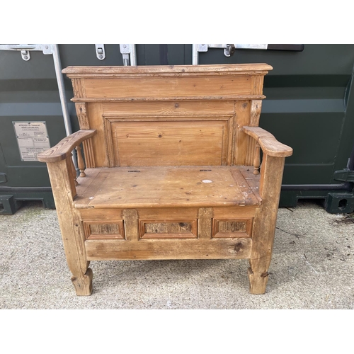 A small pine monks bench with storage