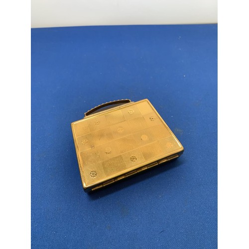 Mascot musical novelty compact in the form of a ladies handbag