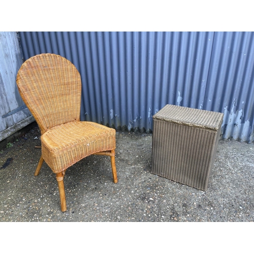 A gold lloyd loom box together with a wicker chair