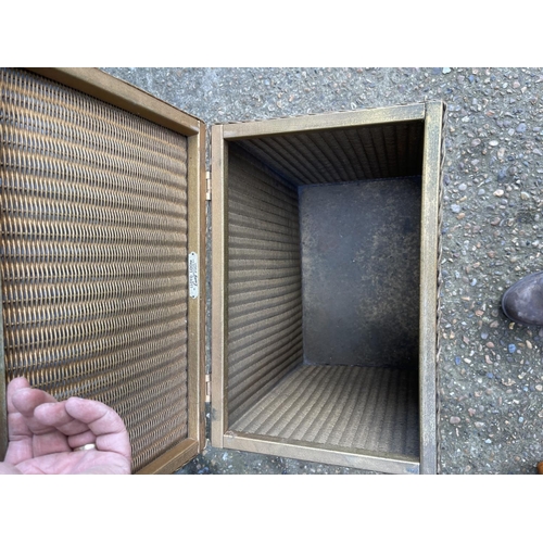 A gold lloyd loom box together with a wicker chair