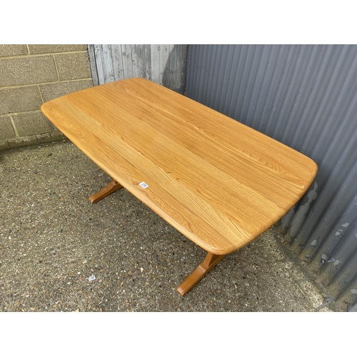 An Ercol light elm refectory dining table 154x84x77