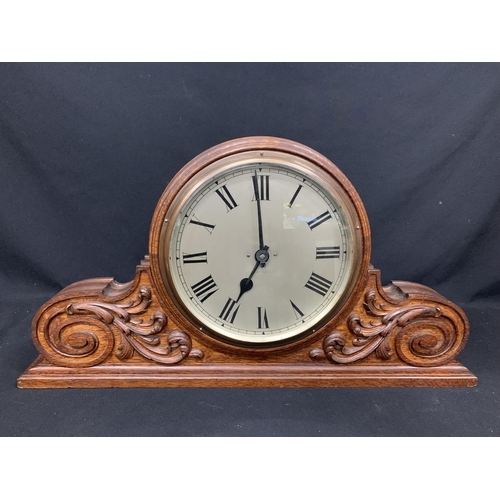 Large Electric clock on carved wooden stand, length of base 82cms ...