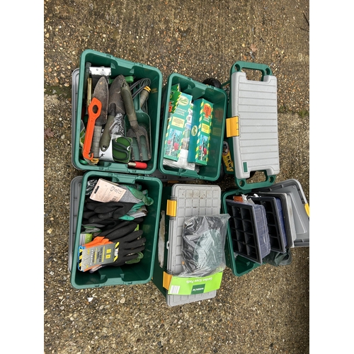 Three green crates and two green tool boxes containing garden hand ...