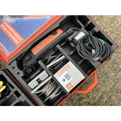 Fein cased multitool together with a fein case containing sanding pads
