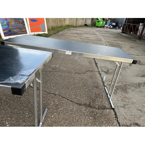 A pair of alu lite folding tables 180x770x90