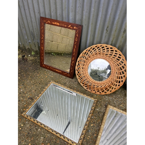 A collection of five wall mirrors