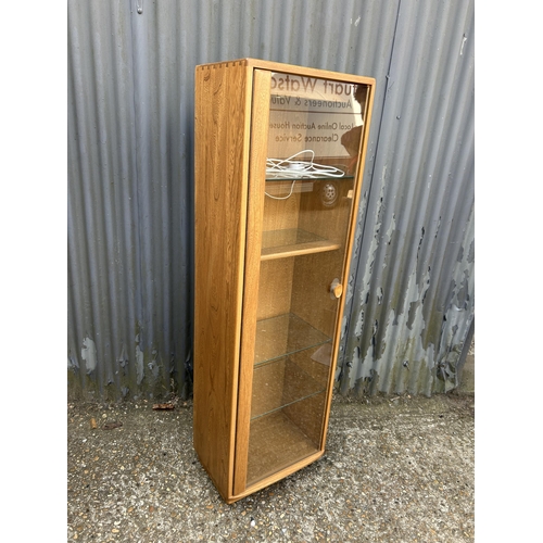 A modern ercol display cabinet with single glass door, adjustable glass ...