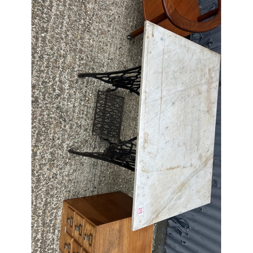A iron based singer sewing machine base with white marble top 76x50x74